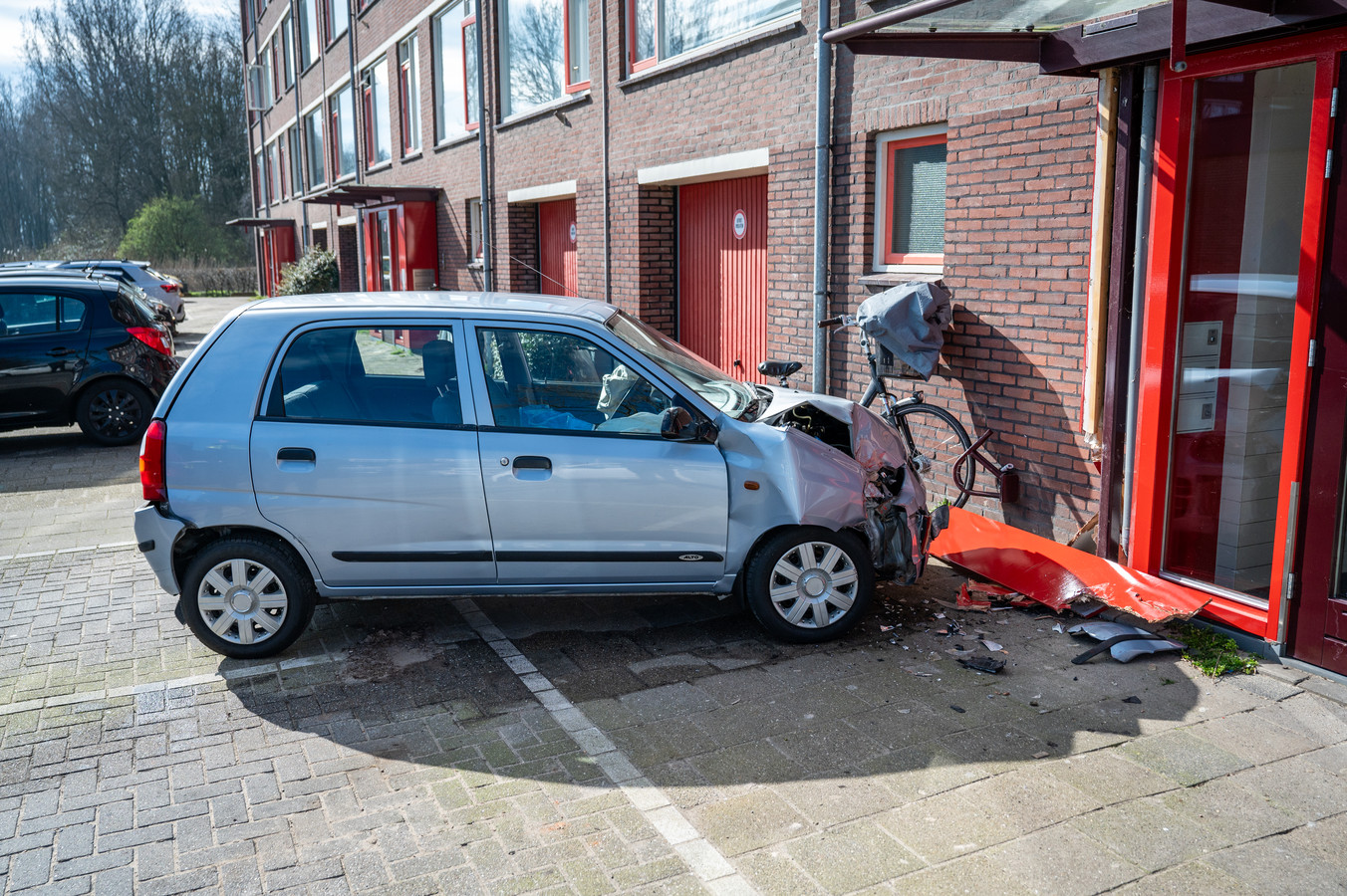 Auto ramt tegen geparkeerde auto’s en portiek, bestuurder gewond en ...