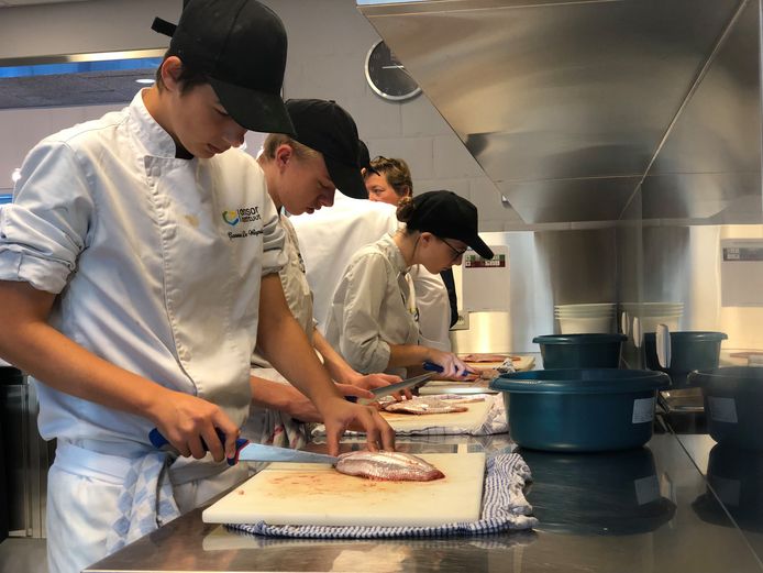 Jongeren leren de kunst van vis fileren. “We willen hen inspireren om ...