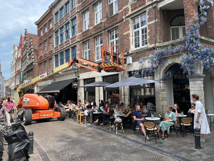 Rustig op een terrasje... tot hoogtewerker boven je hoofd aan de slag ...