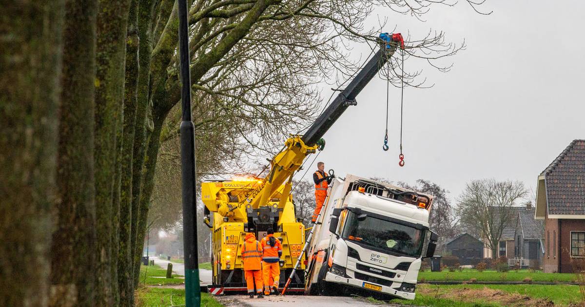 Volle vuilniswagen zakt weg in berm, wegtakelen wordt nog een hele klus ...