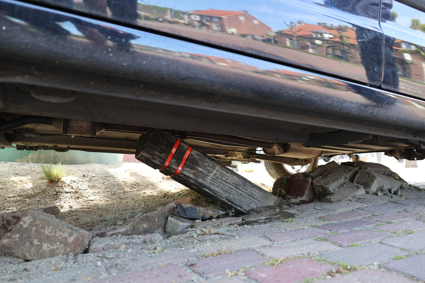 Auto belandt bovenop houten paaltjes in Loon op Zand | Foto | AD.nl